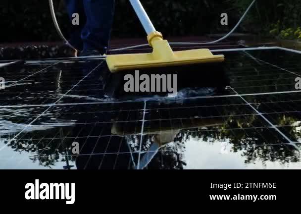 Man washing solar panels with water. fast motion .Solar Panel ...