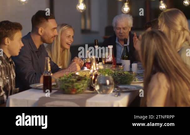 Group of People Sitting Around a Table, Eating, Communicating and ...