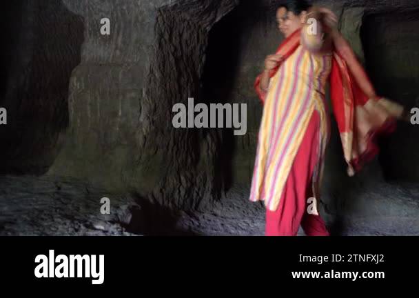 Woman tourist visit to the Ajanta caves and exploring the ancient ...