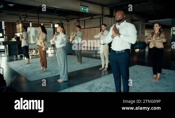 The team in the office is engaged in meditation and yoga. Office ...
