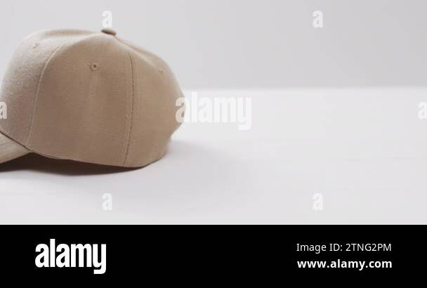 Video of beige baseball cap and copy space on white background ...