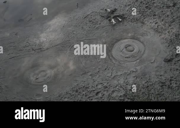 Bubble of gas erupting from a mud pool in the geothermal Waiotapu ...