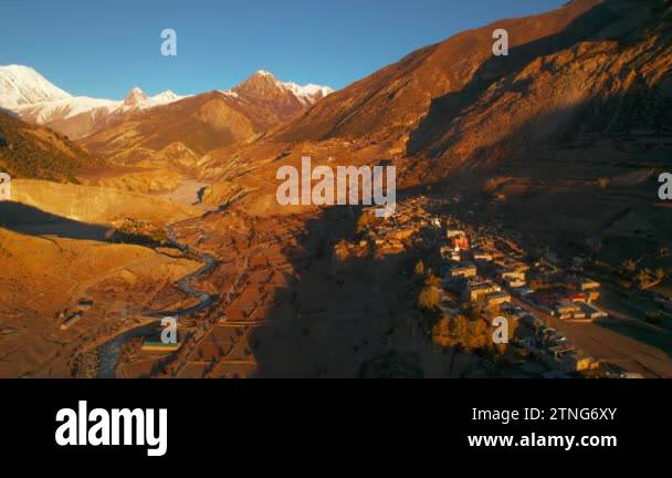 Fly high above majestic valley in high mountain landscape. River and ...