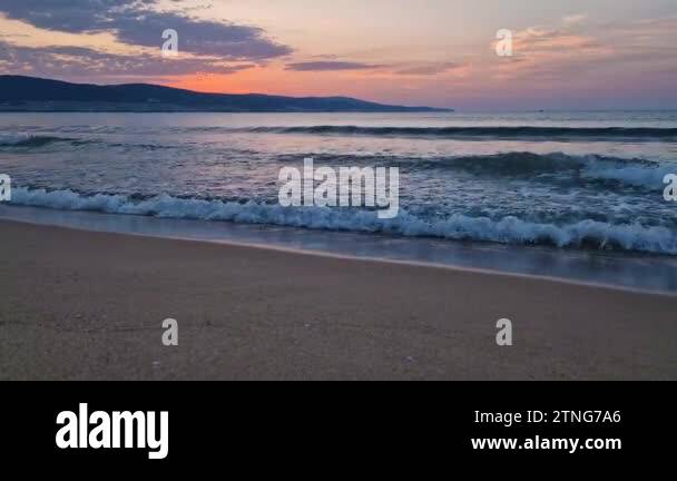 Early morning on the beach with a peaceful view to the sunrise above ...