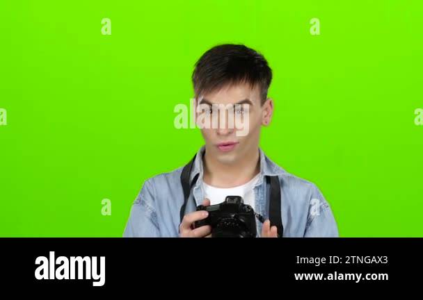 Man takes pictures of the landscapes on the professional camera. Green ...