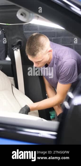 A man does dry cleaning of the car interior, vacuums the car interior ...