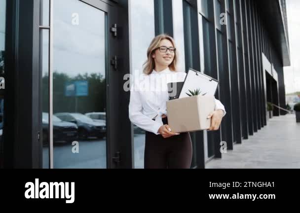 Business woman in glasses walking outdoor after unemployment from ...