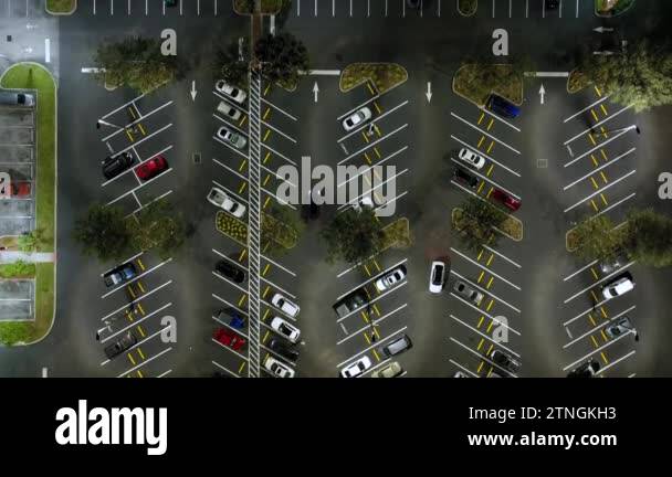 Aerial night view of many cars parked on parking lot with lines and ...
