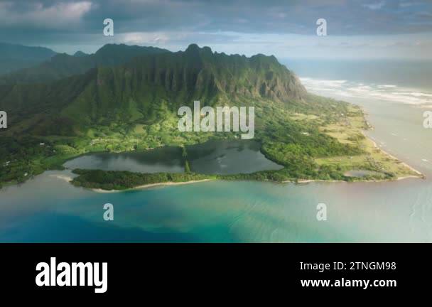 Breathtaking aerial view dramatic mountains, teal blue ocean at Kualoa ...