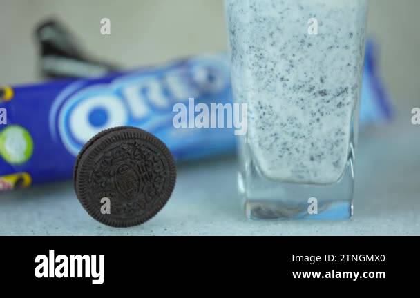 Milk with cookies. Chocolate chip cookies float in milk. Oreo with milk ...