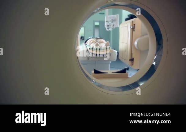Unrecognizable hospital patient lying on MRI, tomograph, scanner ...