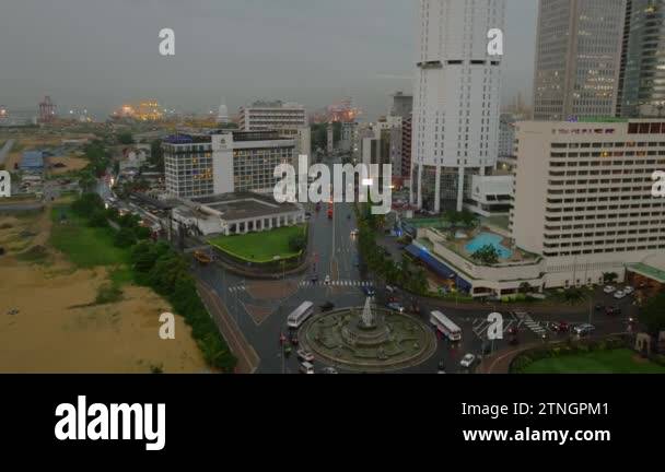 Wet street and buildings in urban borough after sunset. Backwards ...