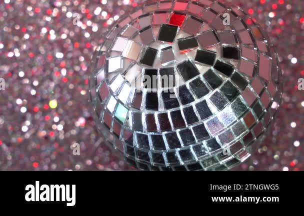 Disco ball filmed in the studio with a silver background and movement ...