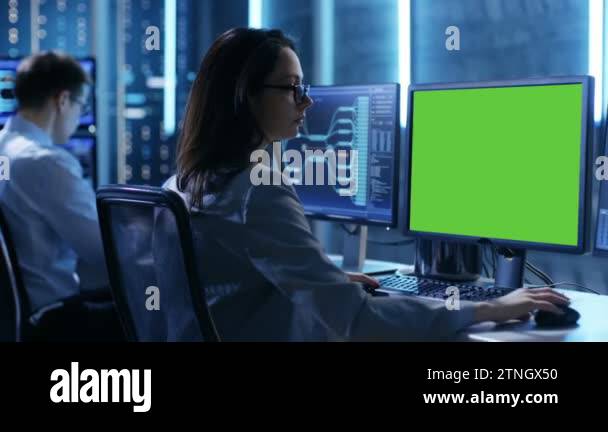 Female Controller/ Operator Working at His Workstation with Multiple Displays (Green Screen Mock ...
