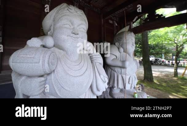 Japanese guardian statues at the traditional street in Tokyo. High ...