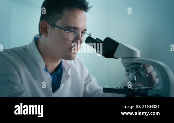 Smart scientist working with High Tech Equipment. Slow motion bright ...