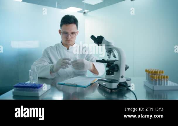 Engineer in white uniform at pro lab 4K. DNA test experiment conducted ...