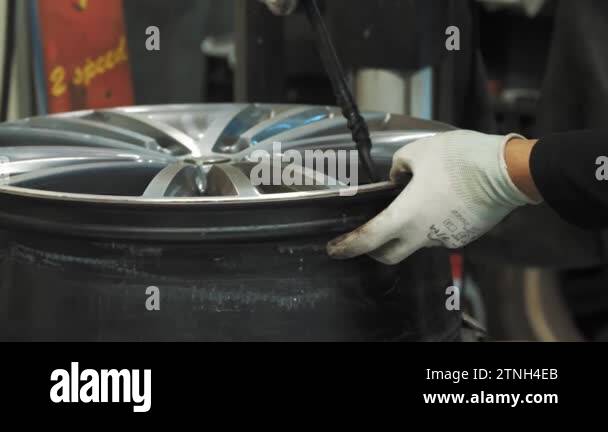Tyre Fitting. Mechanic using hydraulic or mechanical press to remove ...