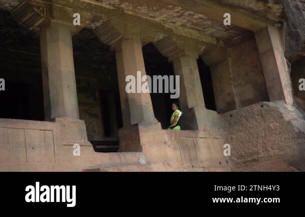 Woman tourist visit to the Ajanta caves and exploring the ancient ...