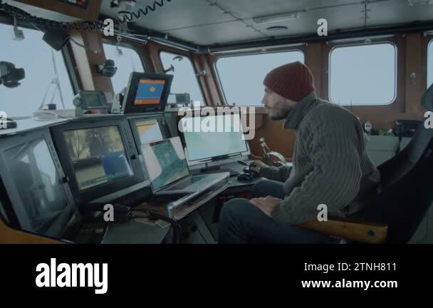 Captain of Commercial Fishing Ship Surrounded by Monitors and Screens ...