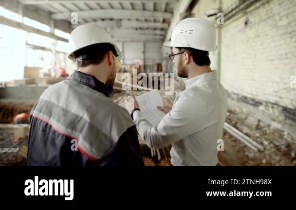 Back view of men in helmets and eyeglasses standing together in ...