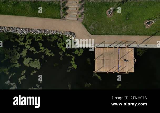 Pier for park visitors. two steps lead to it. planks terrace over water ...