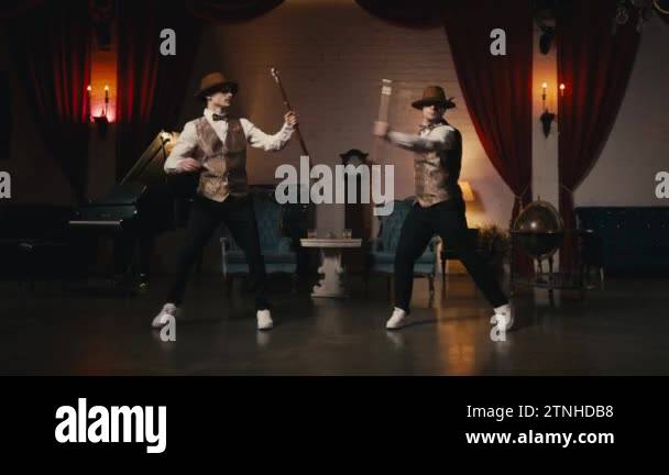 Two stylish professional male dancers in classy dandy hat performing ...