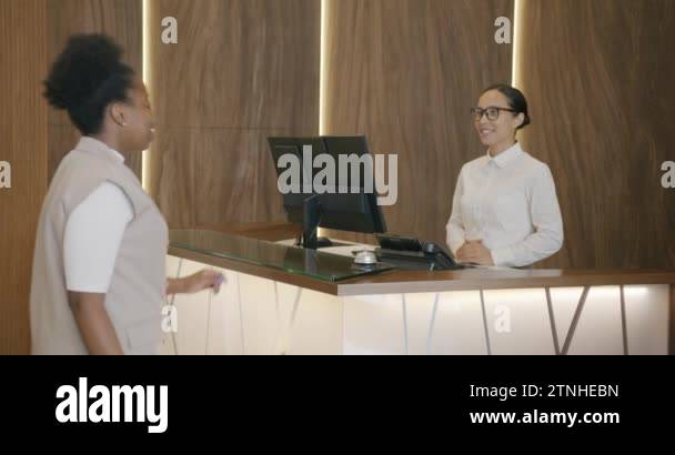 Man woman in the conversation with receptionist in the hotel Stock ...