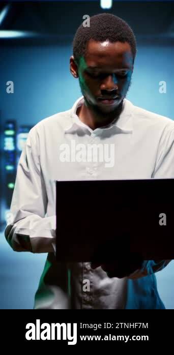 Vertical video Computer scientist walking between data storage devices ...