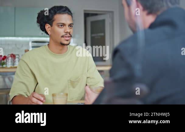 Two buddies talking coffee house sharing news in cozy institution ...