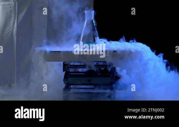 Bottle and liquid nitrogen in a laboratory. Chemical experiment. Flask ...