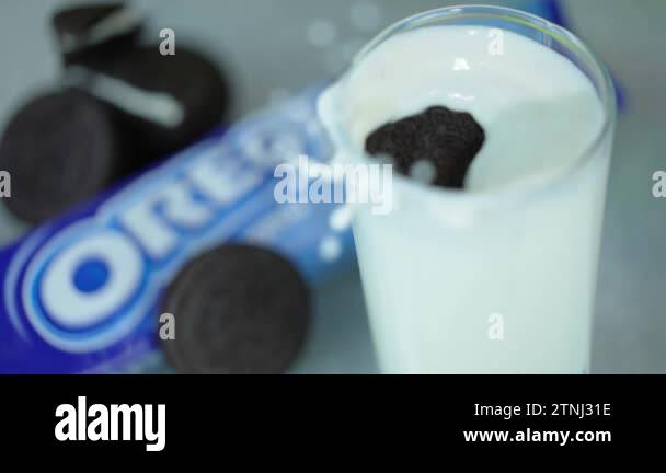 Milk with cookies. Chocolate chip cookies float in milk. Oreo with milk ...