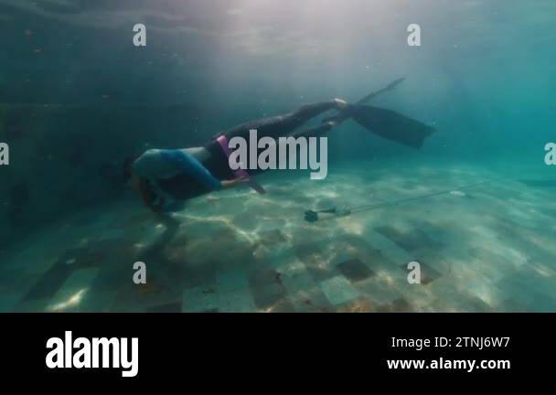 Freediver trains in the pool. Woman freediver works out in the pool ...