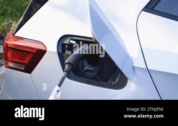 Electric vehicle charging port plugging in EV modern car. Save ecology ...