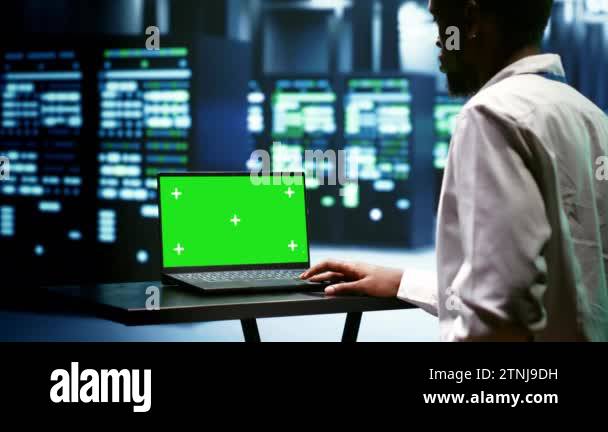 Electrician auditing server clusters doing intense computations. Serviceman using chroma key ...