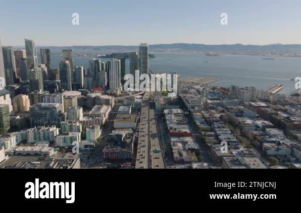 Heavy traffic on multilane freeway leading around downtown and heading ...