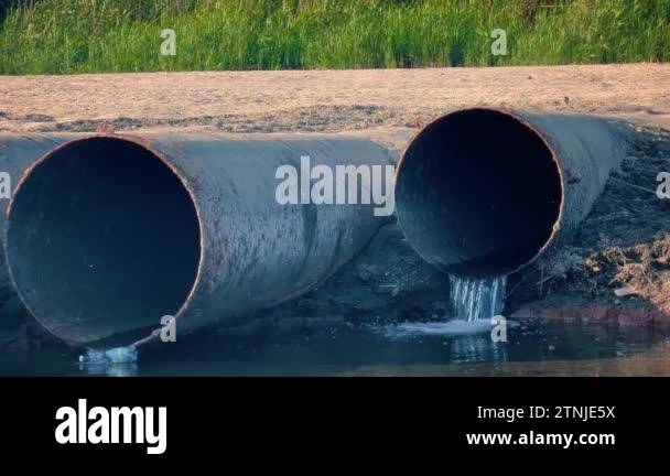 Discharge of industrial toxic waste through large diameter pipes Stock ...