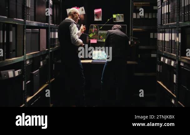 Police agents review board with clues to piece all puzzle together and ...