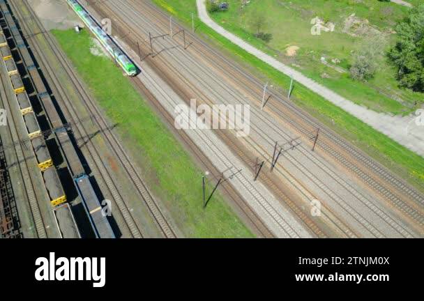 Flying above industrial railroad station with cargo trains and freight ...