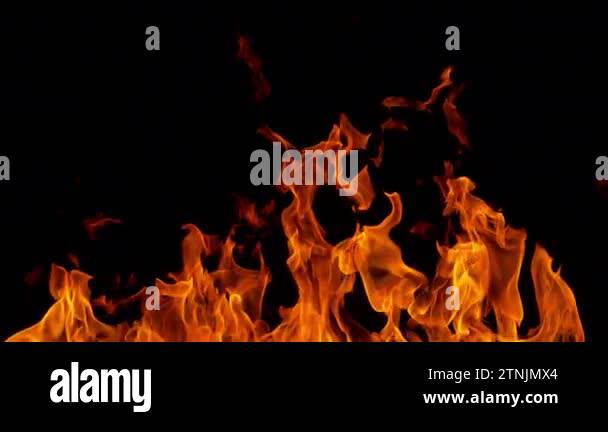 Super slow motion of fire flames isolated on black background. Filmed ...