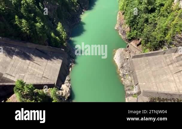 Tilt up shot from the top of Ross Dam to show the flowing river below ...