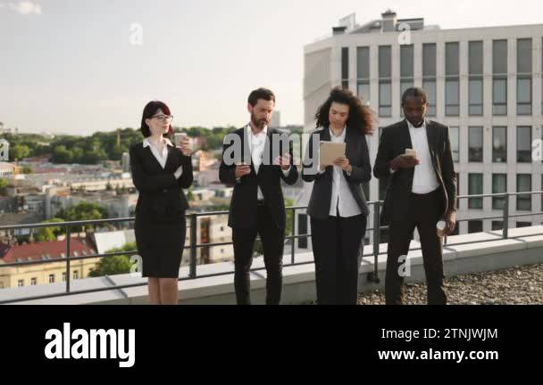 Group of young professionals taking short coffee break and enjoying hot ...