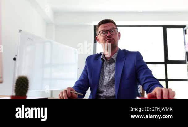 Angry businessman screaming and pointing at camera in office. Portrait ...