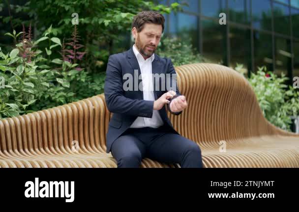 Sad man sitting on bench scratching body has dry skin problems ...