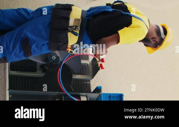 Vertical video Proficient worker calibrating set of barometer ...