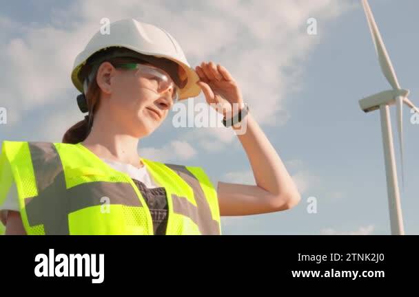Watching a wind turbine, a female engineer becomes the personification ...