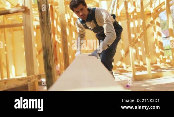 man in uniform and headphones carrying board at construction site Slow ...