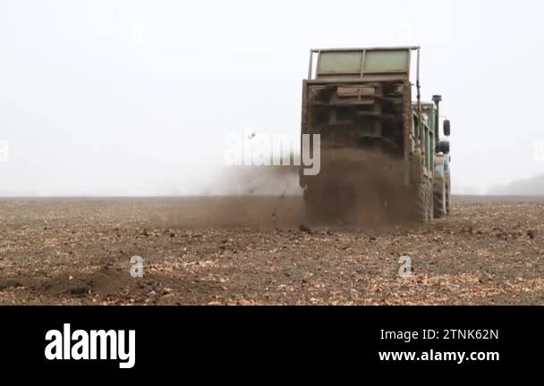 Fertilizing fields with compost. Fertilization of earth with organic ...