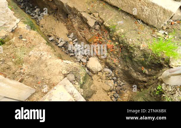 Pouring, laying concrete into foundations of the house using shovel of ...