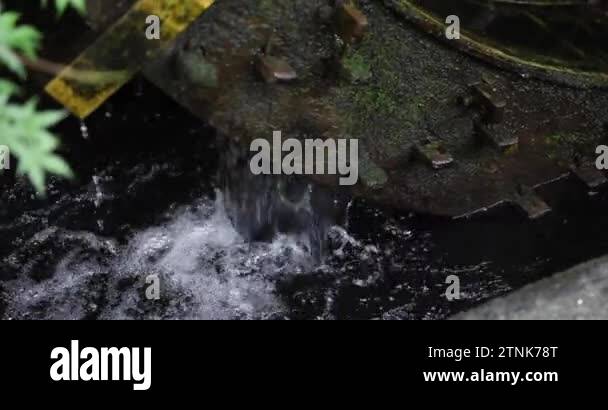 A historic wooden wheel on the water surface in Tokyo. High quality 4k ...